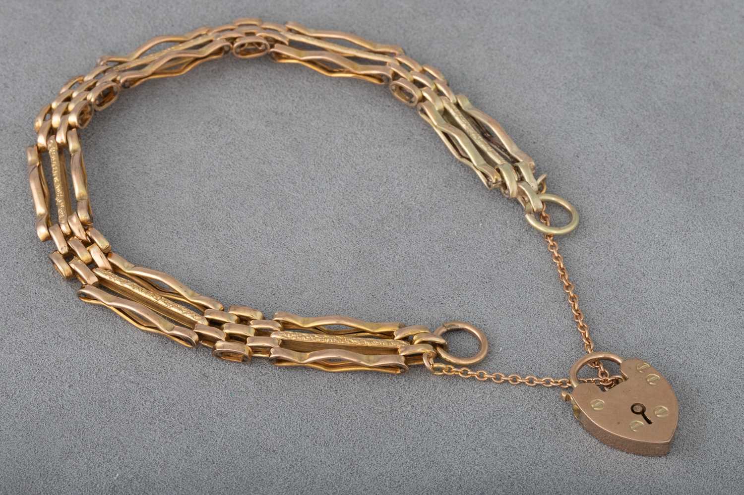 Lot 180 - A 9CT GOLD GATE BRACELET, engraved