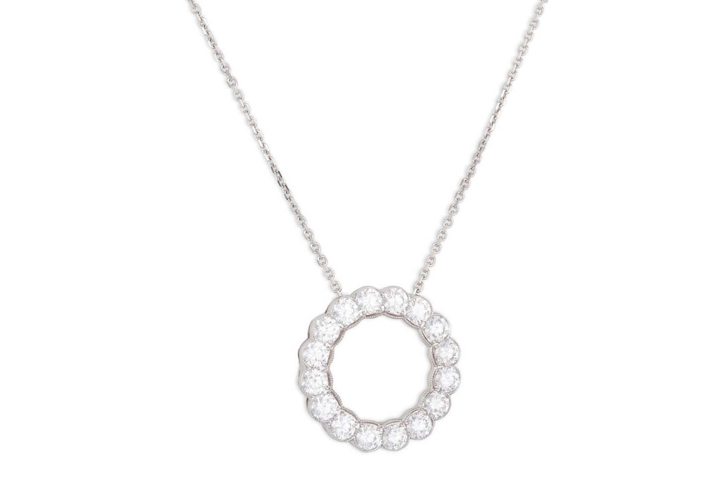 Lot 123 - A DIAMOND CLUSTER PENDANT, of open circular