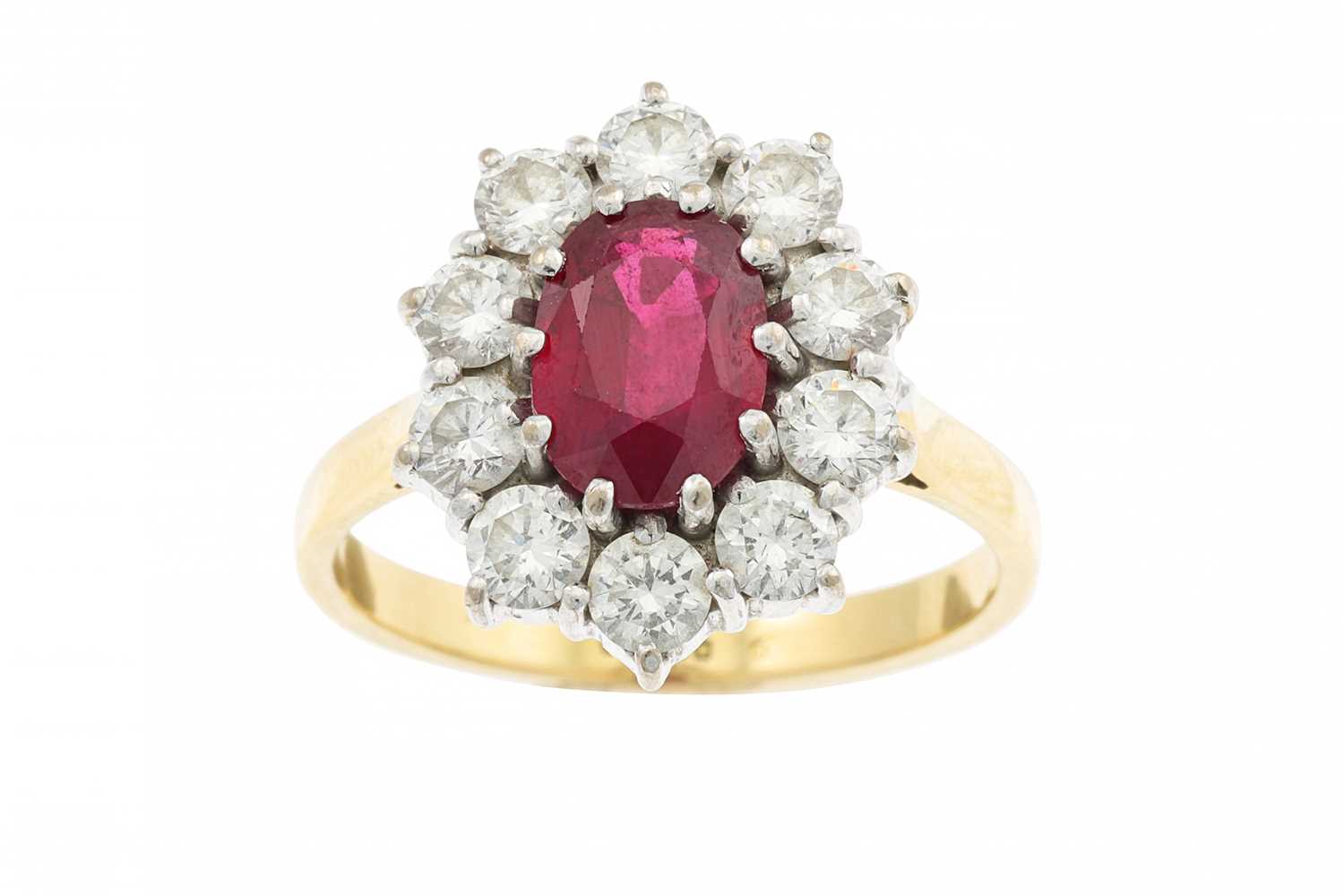 Lot 378 - A RUBY AND DIAMOND CLUSTER RING, mounted in