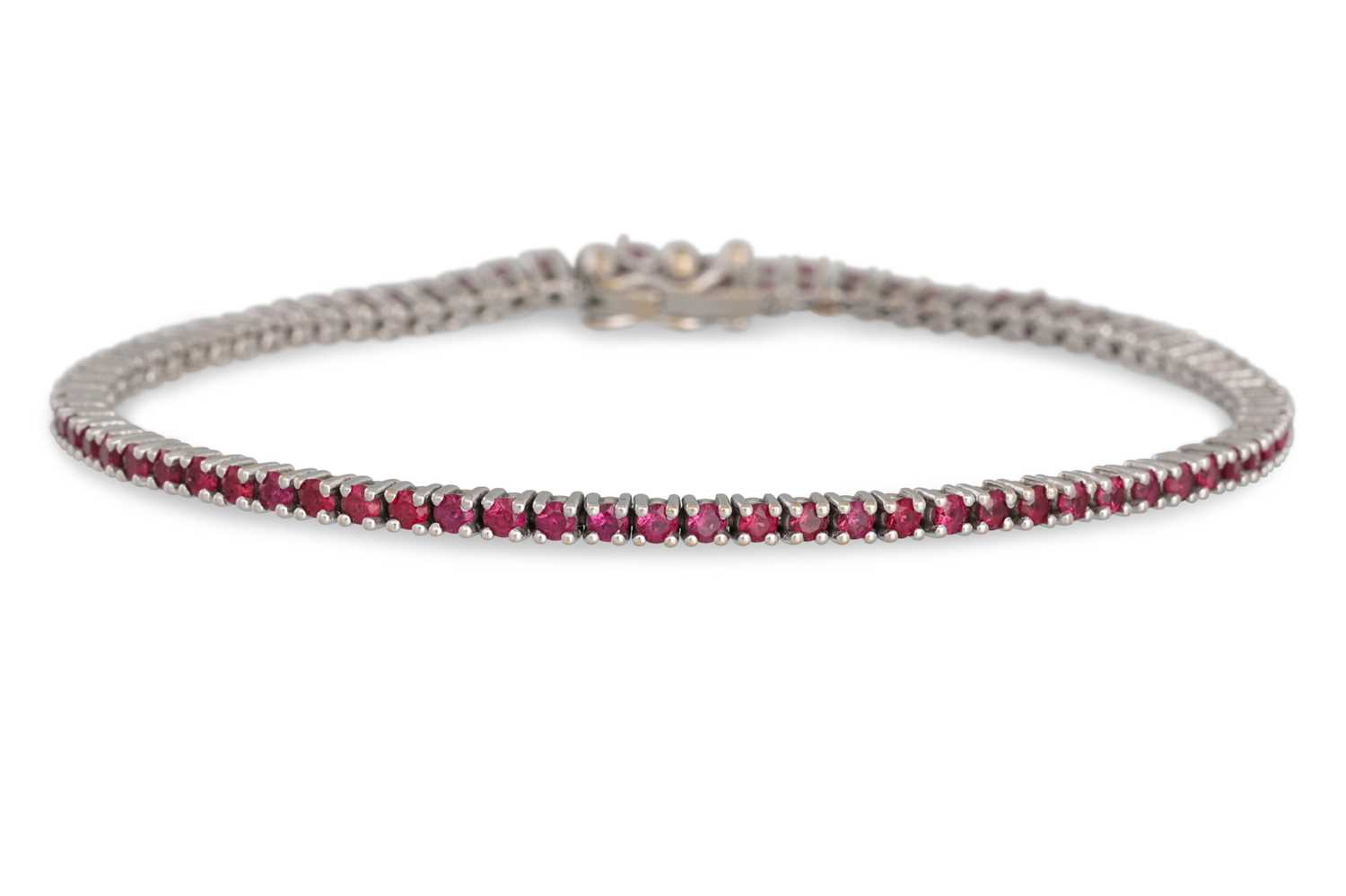 Lot 248 - A RUBY LINE BRACELET, mounted in 18ct white